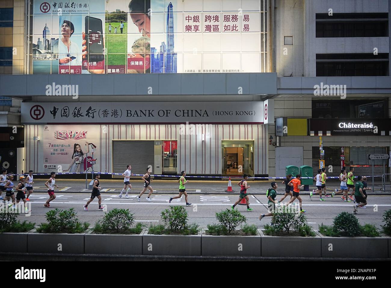 Participants run along Nathan Road during the Hong Kong Marathon 2023 ...