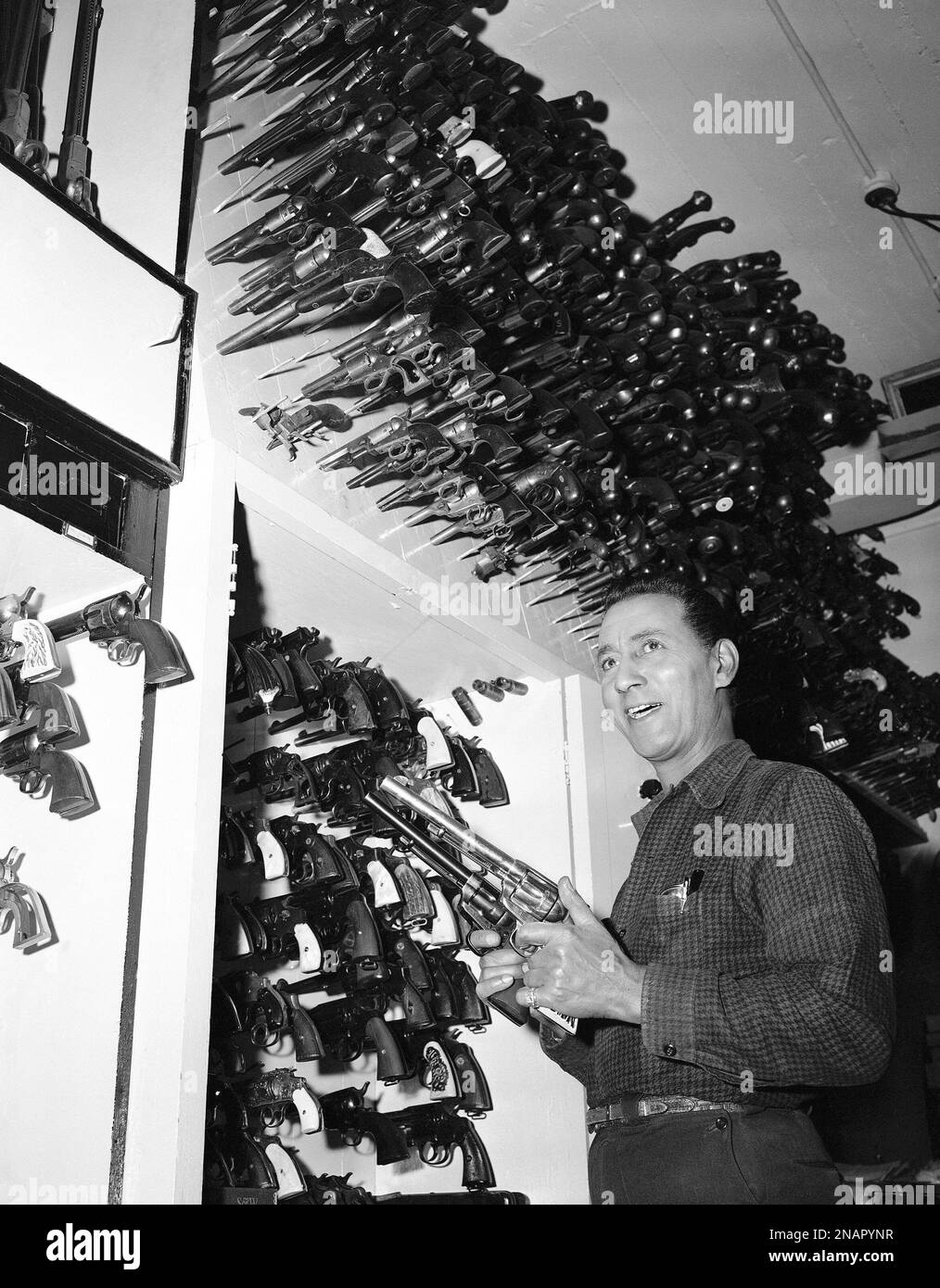 Selecting a pair of six-guns from the Hollywood studio’s gun department ...