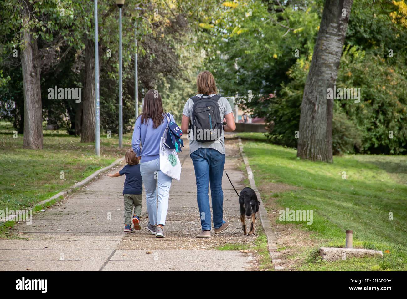 Family with kid enjoying park walk on sunny weekend day Stock Photo - Alamy