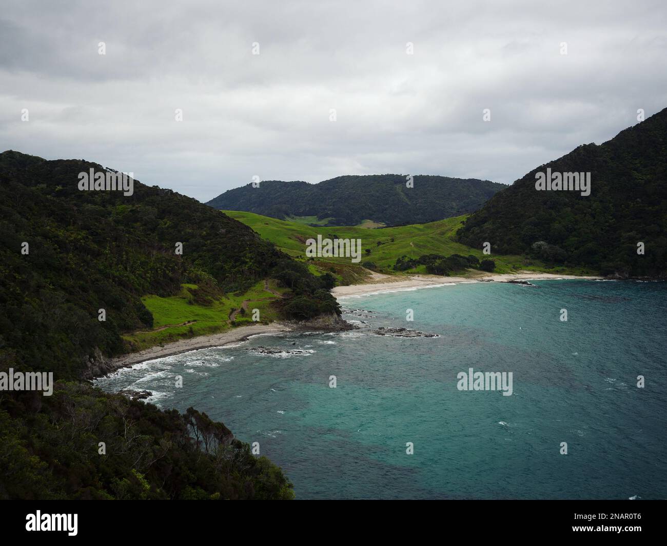 Smugglers Bay beach with lush green grass nature landscape panorama ...