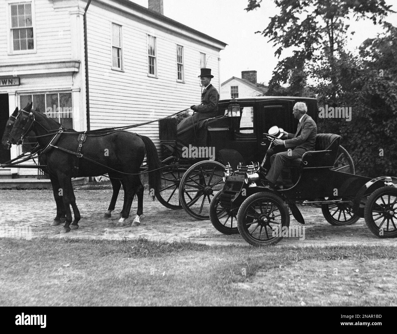 Henry Ford, automobile magnate, viewing a model of transportation on ...