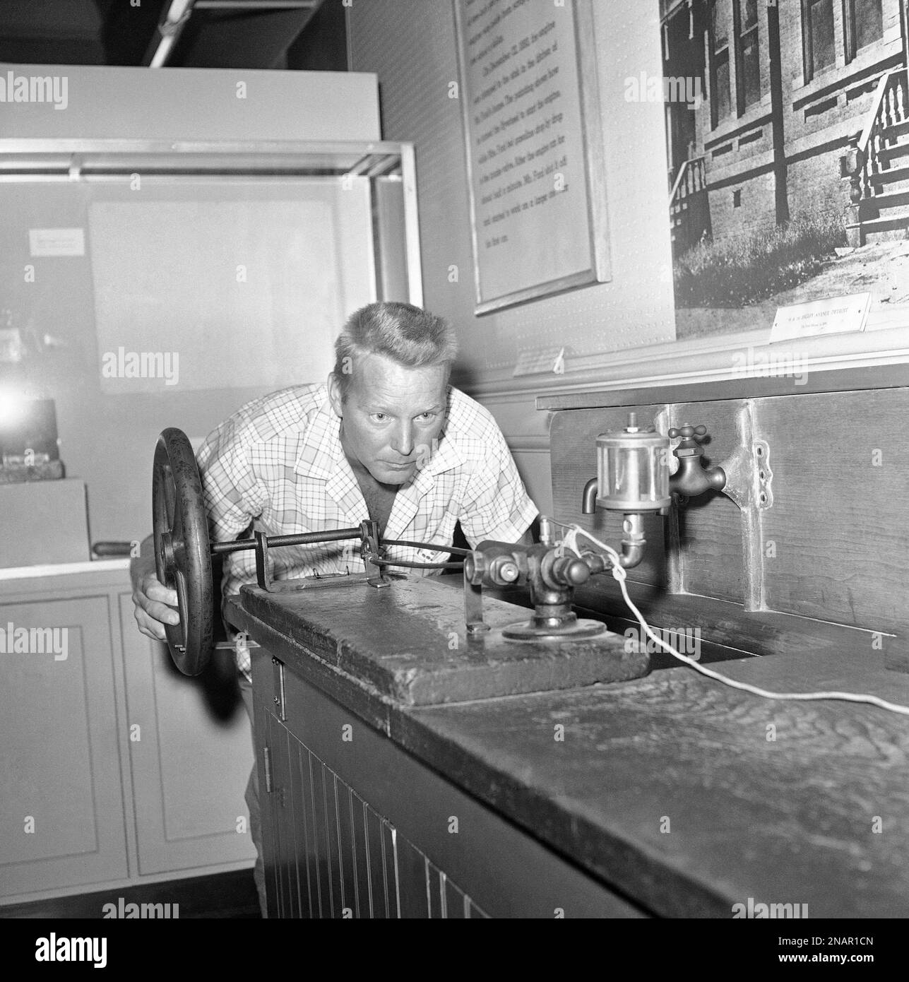 The first gasoline engine built by Henry Ford is looked over by Richard ...