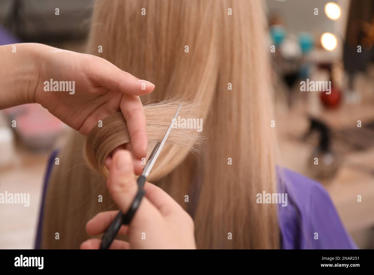 Stylist cutting hair of client in professional salon, closeup Stock ...