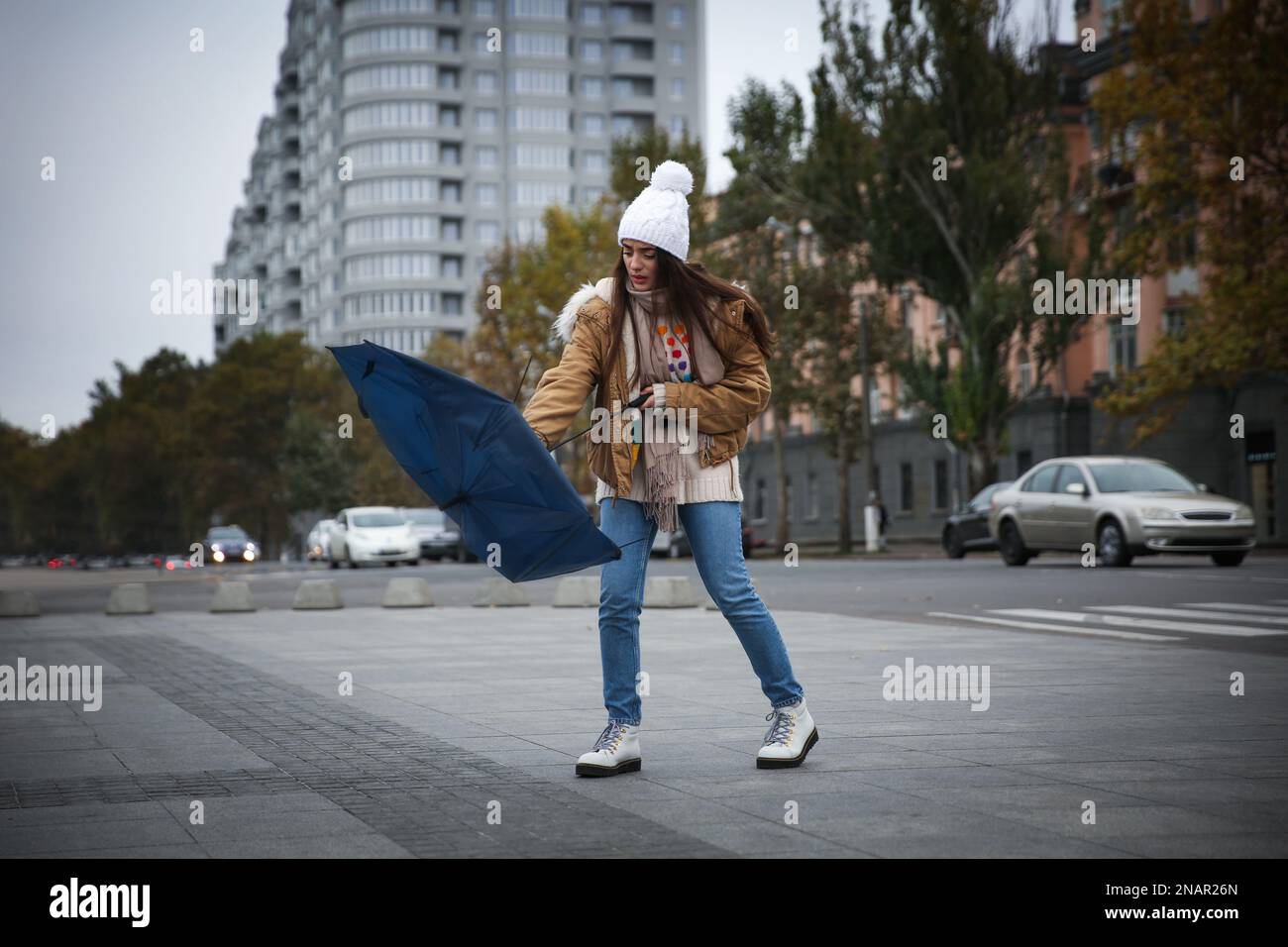 Woman struggling in rain and wind hi-res stock photography and images ...
