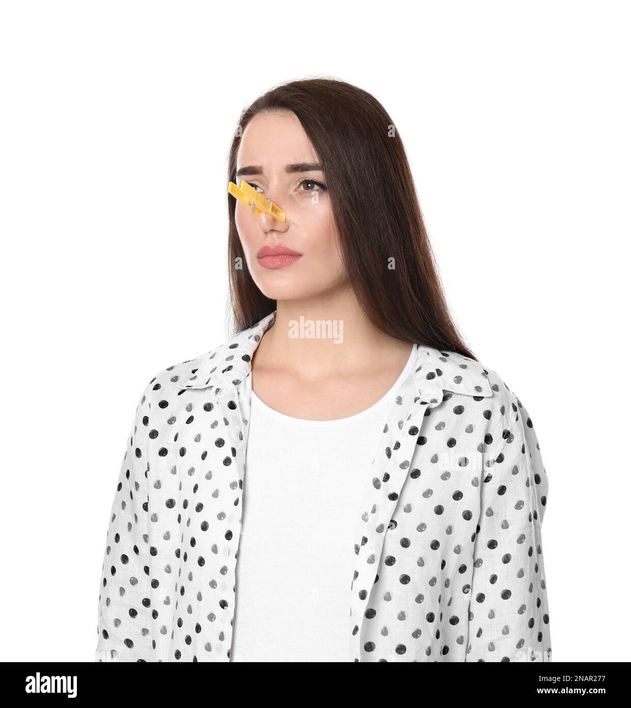 Young woman with clothespin on white background. Runny nose concept ...