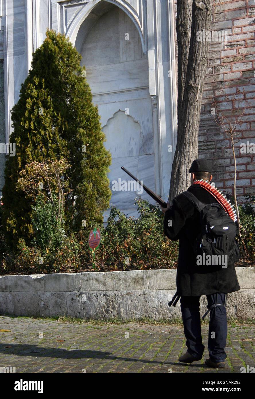 A heavily armed gunman walks inside the courtyard of Ottoman-era ...
