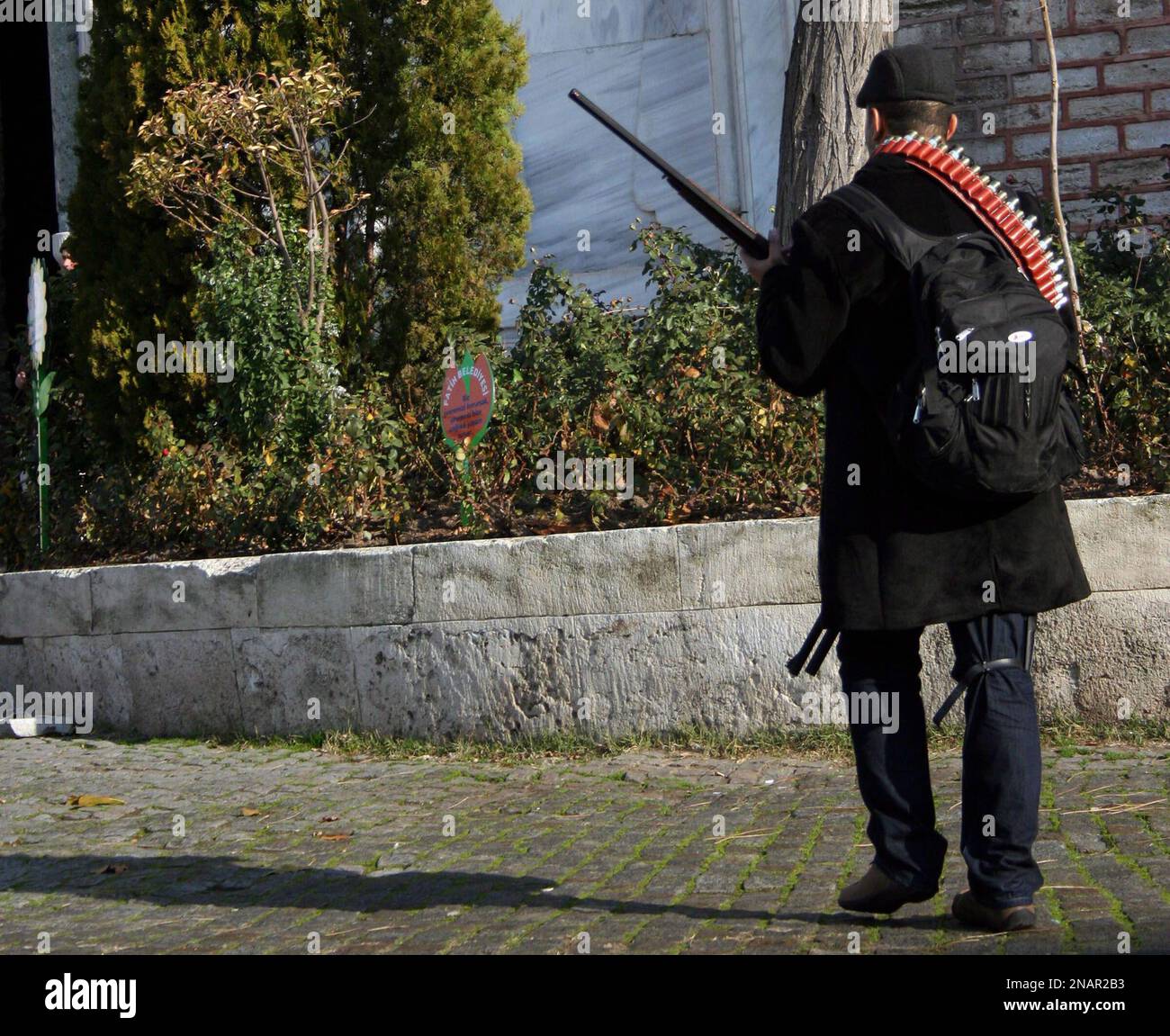 A heavily armed gunman walks inside the courtyard of Ottoman-era ...