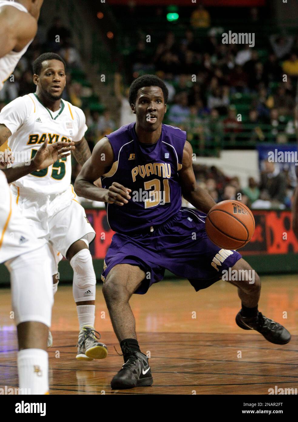 Prairie View A&M's Montrael Scott (31) drives past Baylor guard Pierre ...