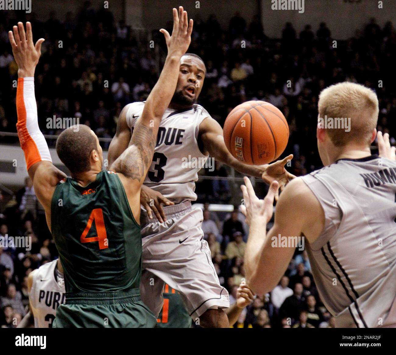 Purdue guard Lewis Jackson, center, passes off to forward Robbie Hummel ...