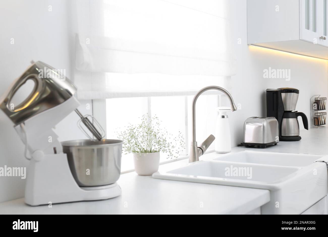 Modern toaster and household appliances on counter in kitchen Stock ...