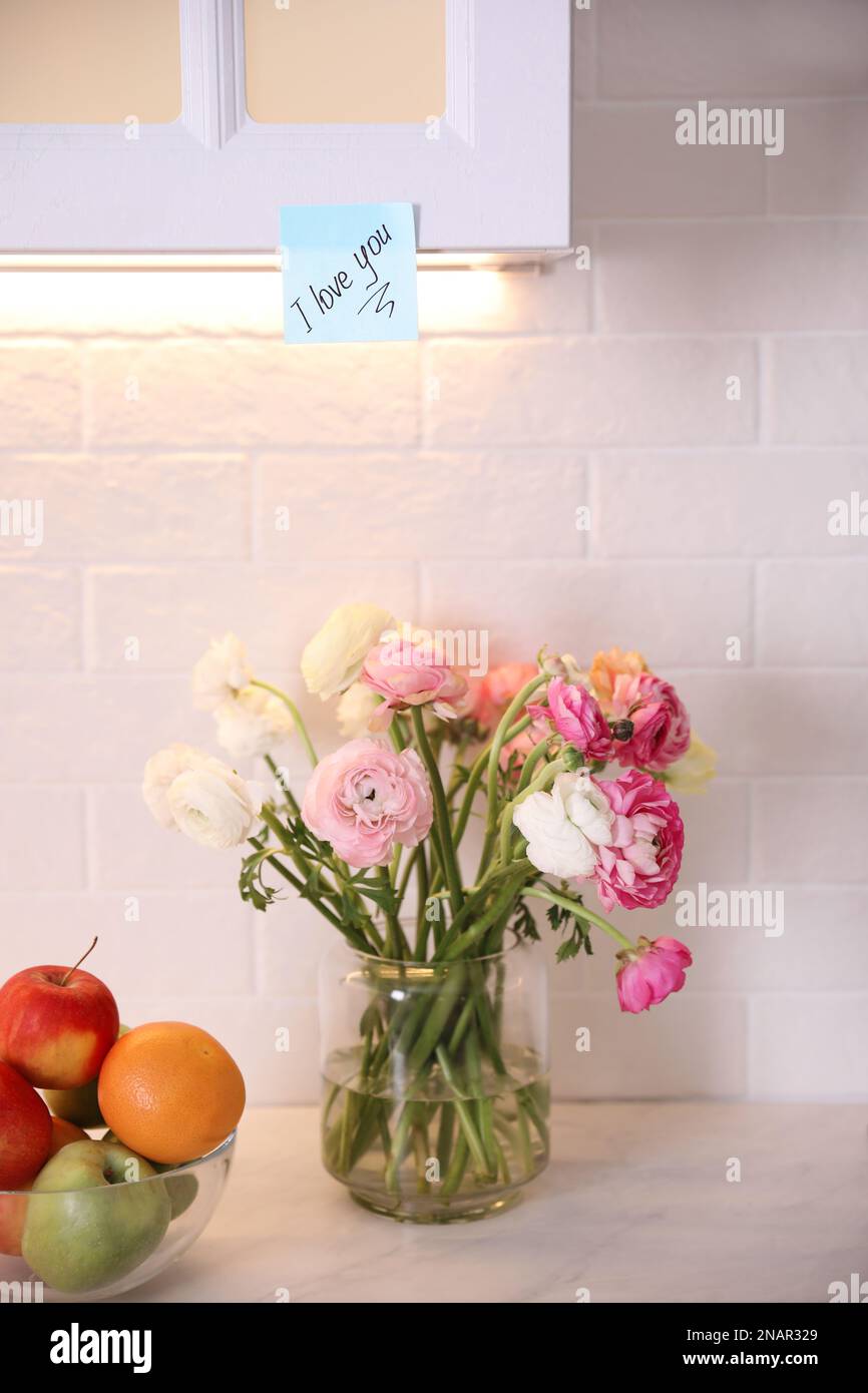 Sticky note with handwritten text I Love you on cupboard door in ...