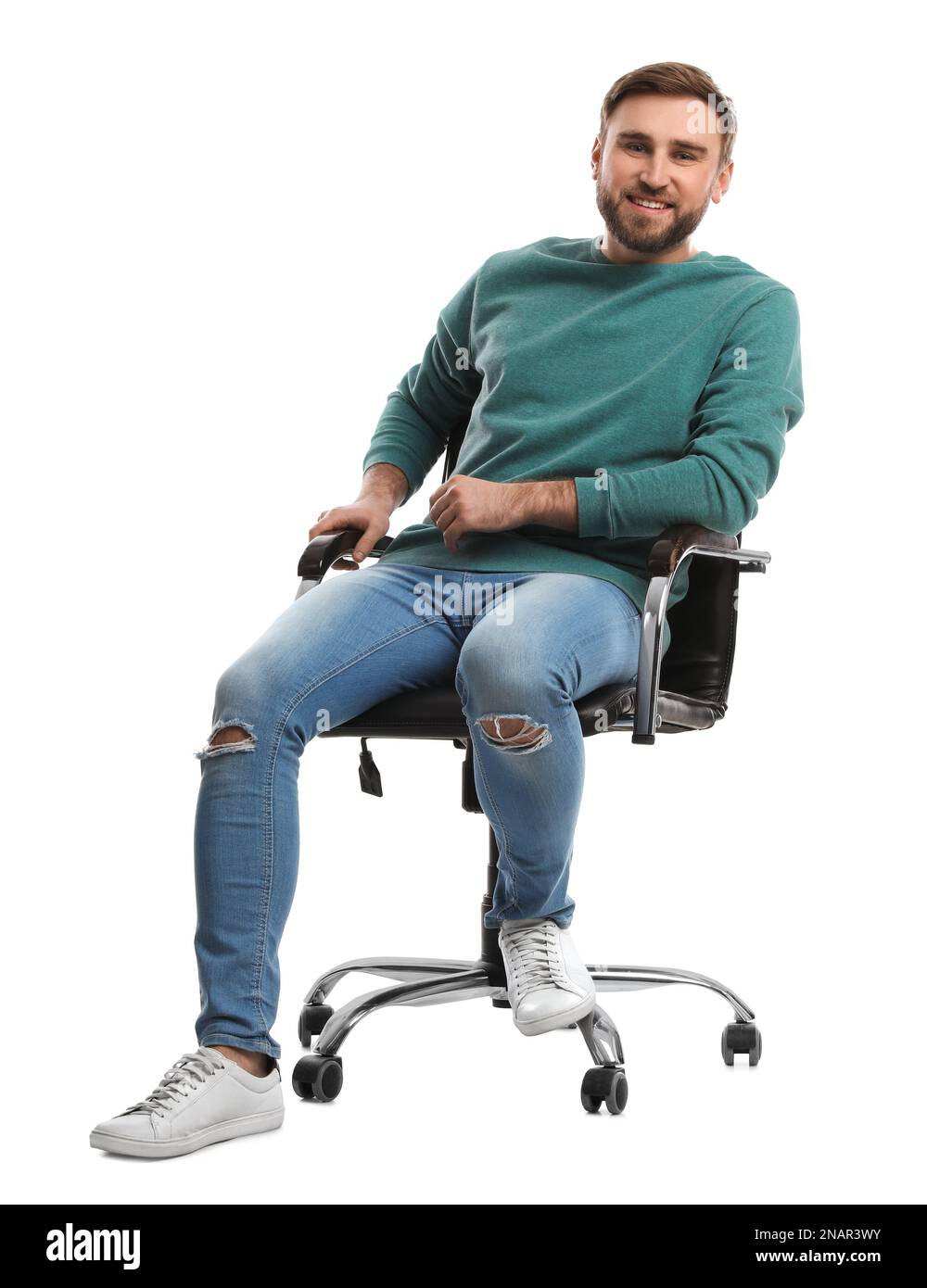 Young man sitting in comfortable office chair on white background Stock ...