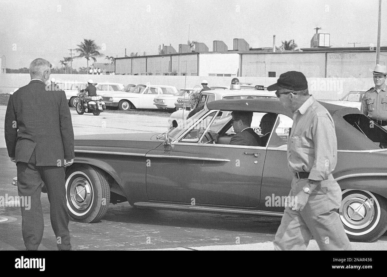 President John F. Kennedy drives car, a Dodge Dart, with his father ...