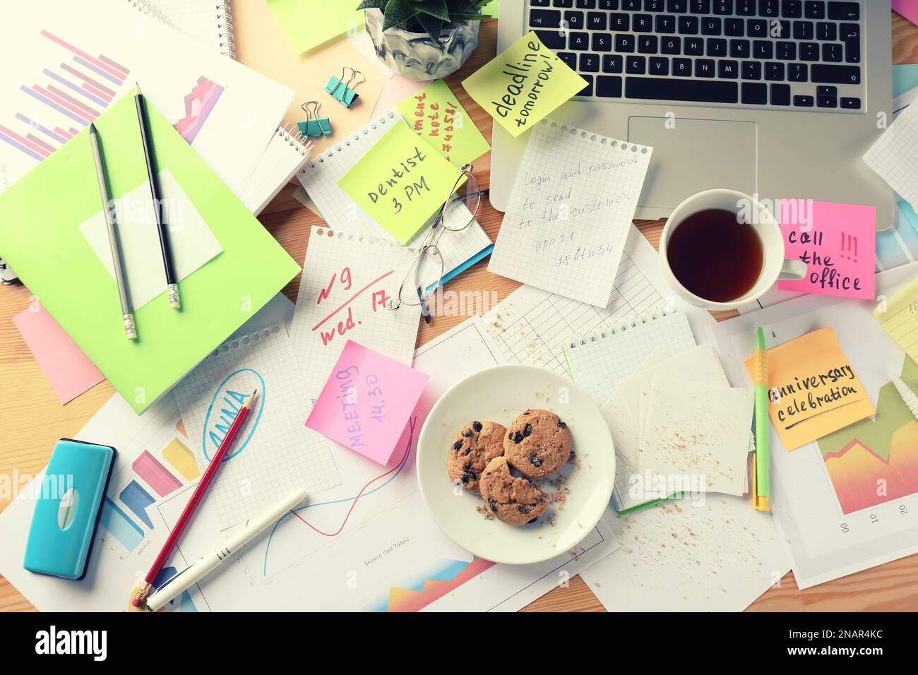 Messy table with laptop, cookies and tea, flat lay. Concept of being ...