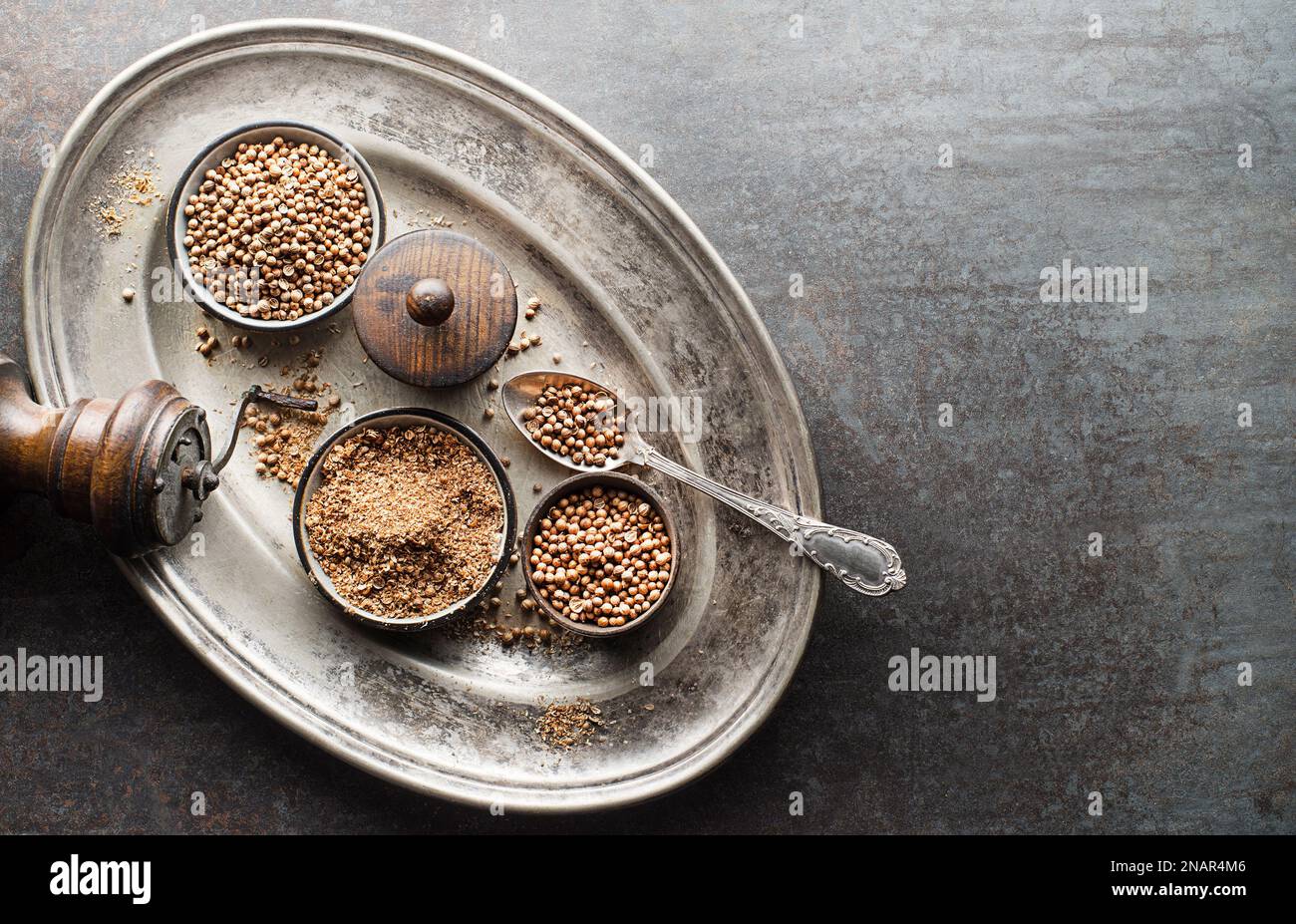 Organic Dried coriander seeds (Coriandrum sativum) and powder on rustic ...