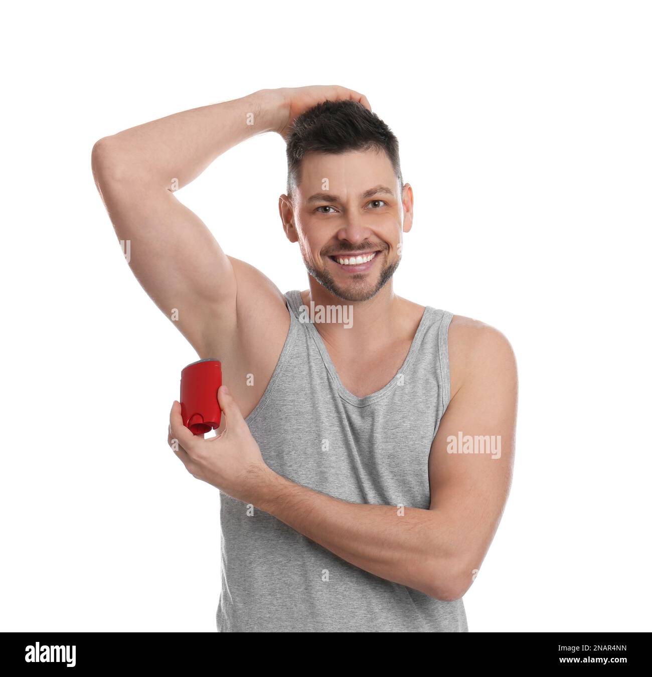 Handsome man applying deodorant isolated on white Stock Photo - Alamy