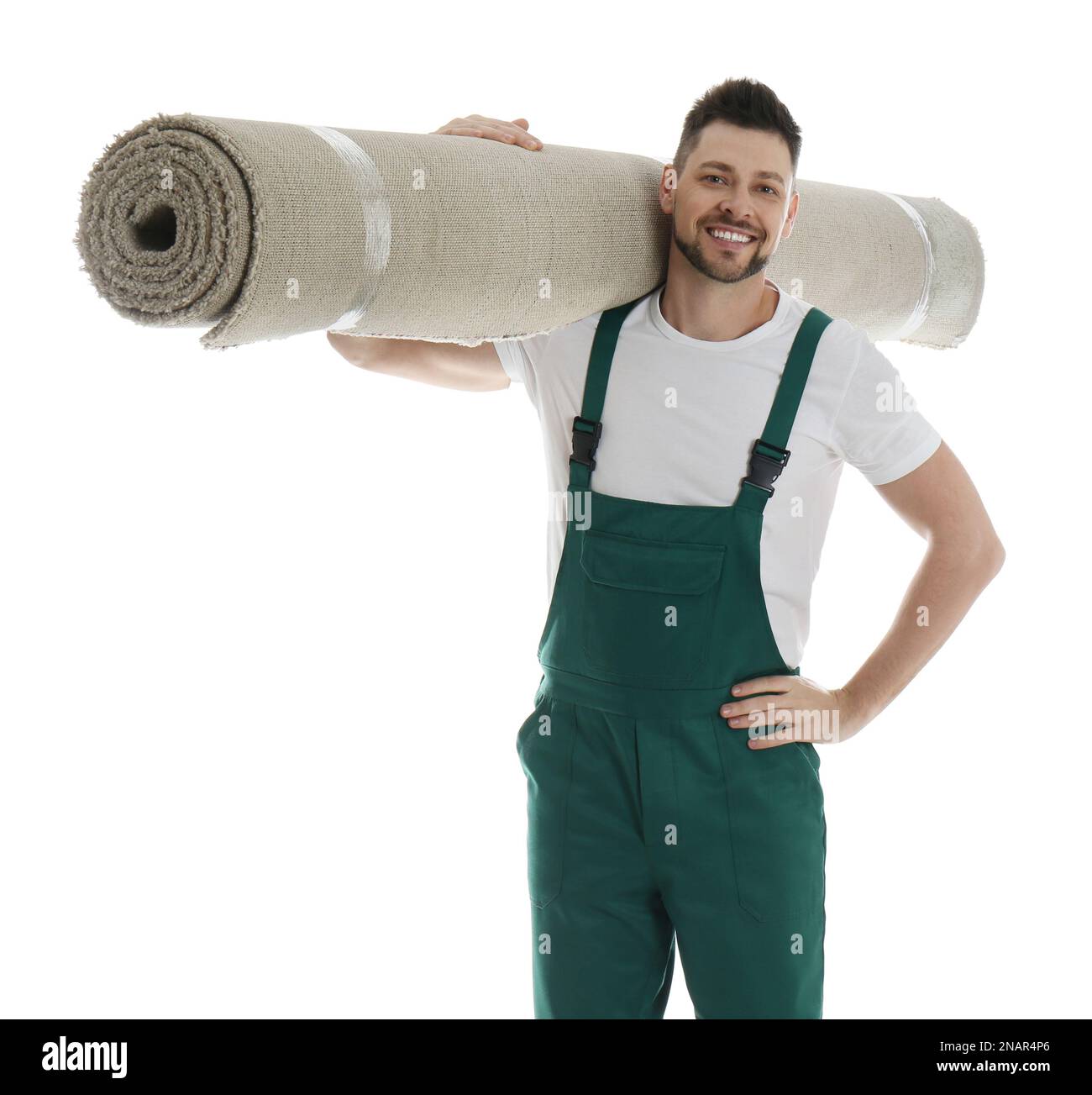 Male worker with rolled carpet on white background Stock Photo - Alamy
