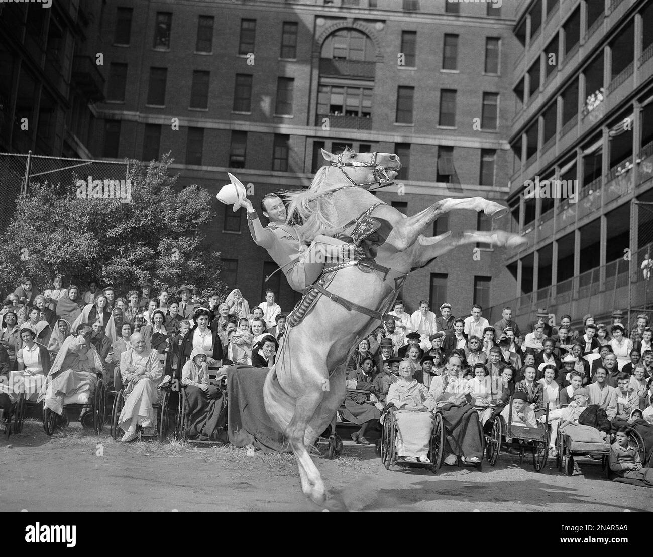 Roy Rogers, featured performer of the rodeo, stunts with his horse ...
