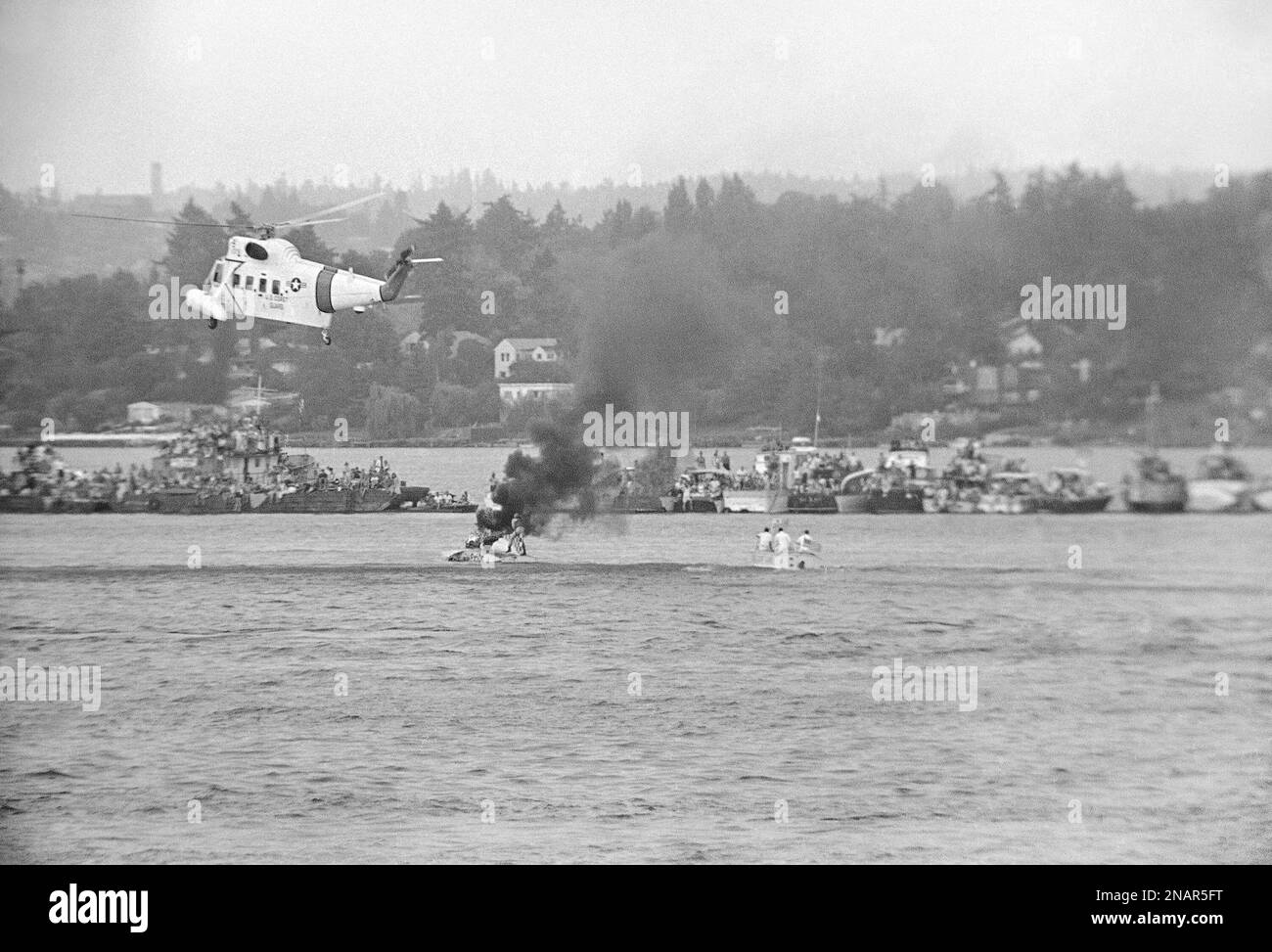 Miss Exide, piloted by Bill Brow of Seattle burns as a Coast Guard ...