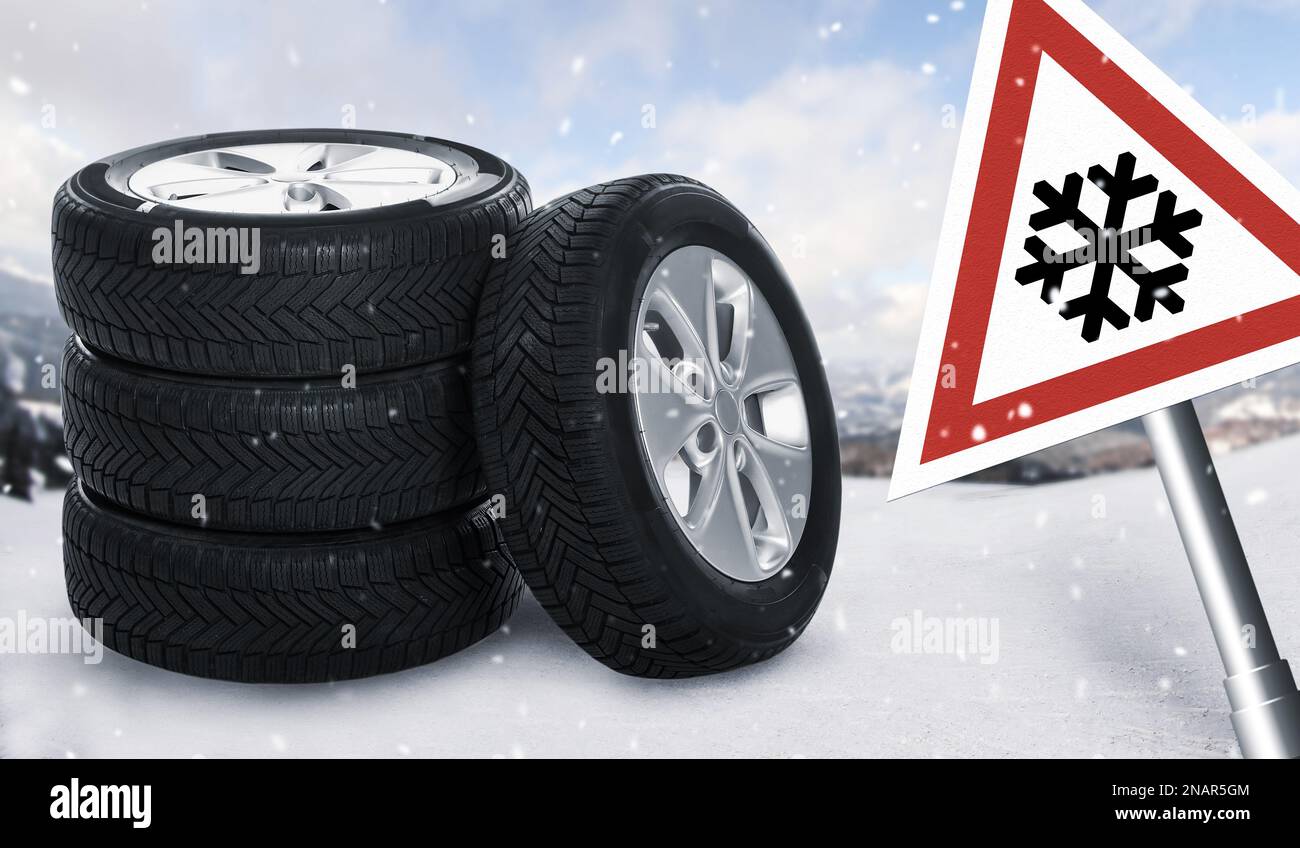 Set of wheels with winter tires on snow and road sign outdoors Stock Photo - Alamy