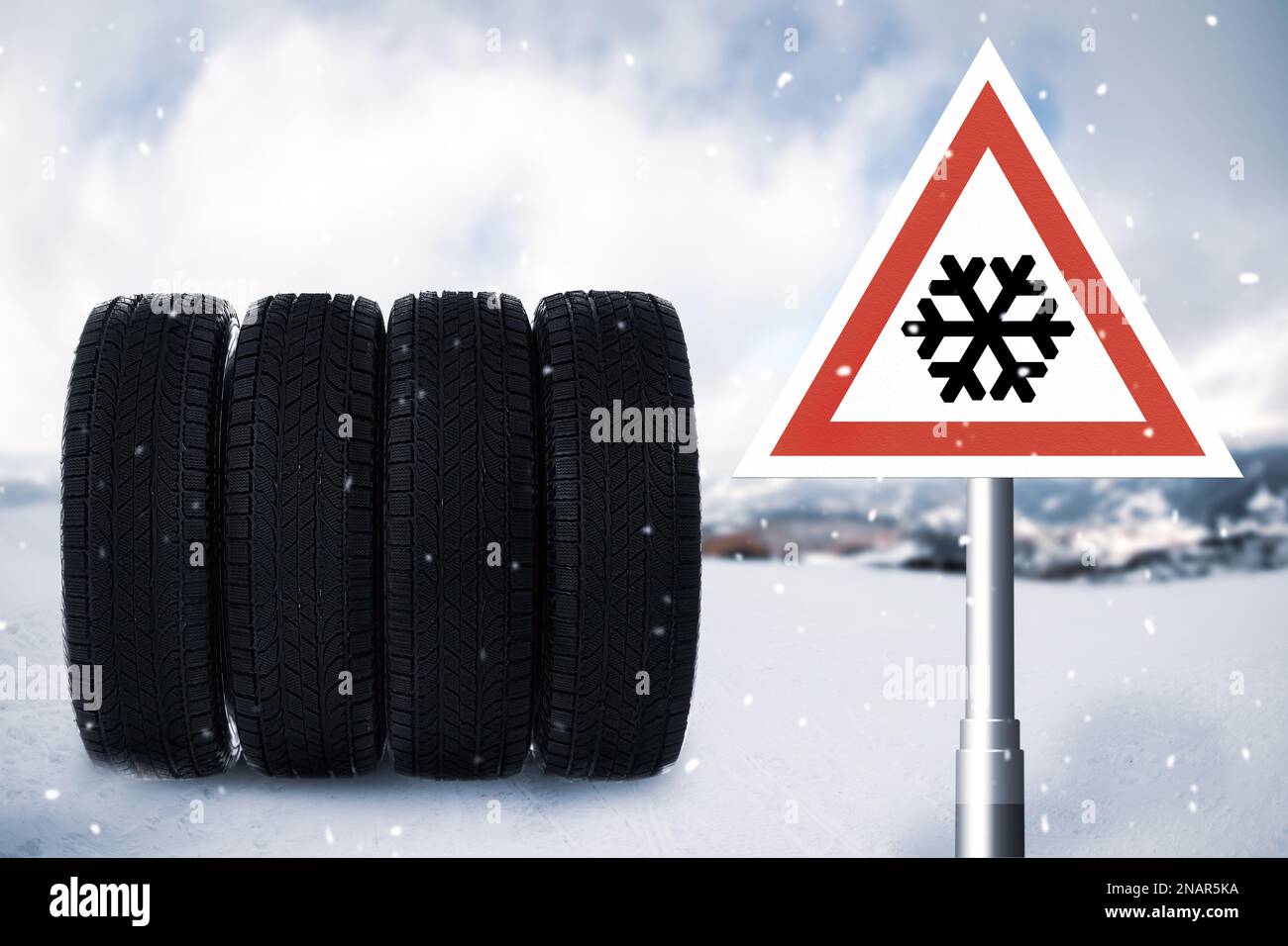 Set winter tires on snow and road sign outdoors Stock Photo - Alamy