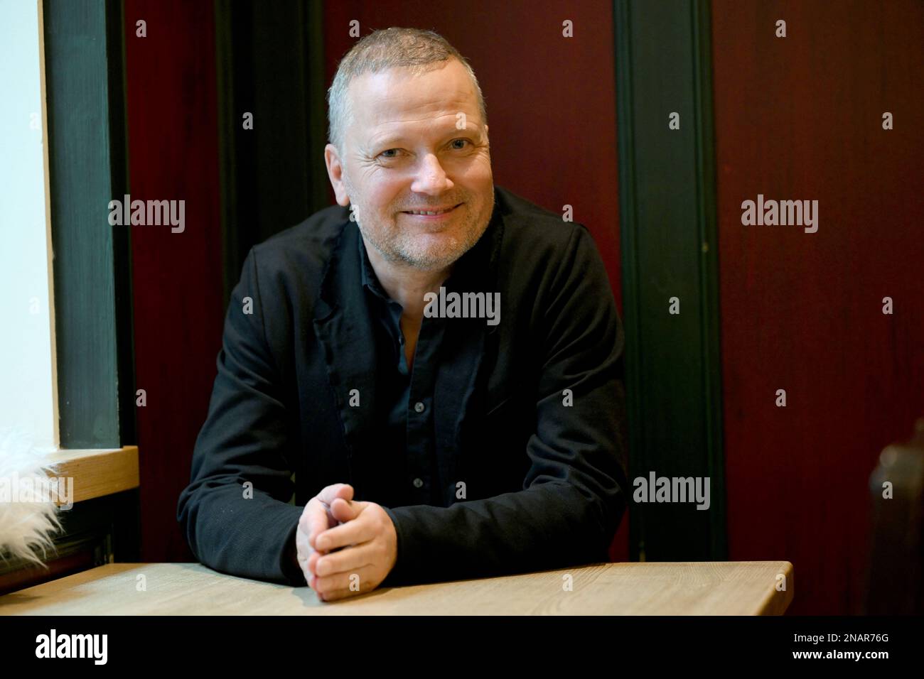 Munich, Germany. 13th Feb, 2023. Actor Christian Pfeil smiles into the ...