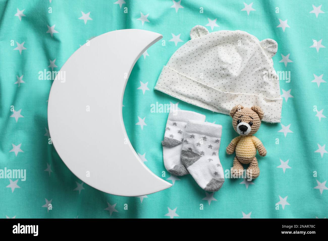 Flat lay composition with crescent shaped child's night lamp on ...
