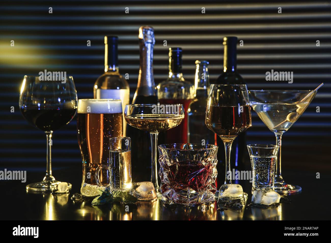 Many different alcoholic drinks on table against dark background Stock ...