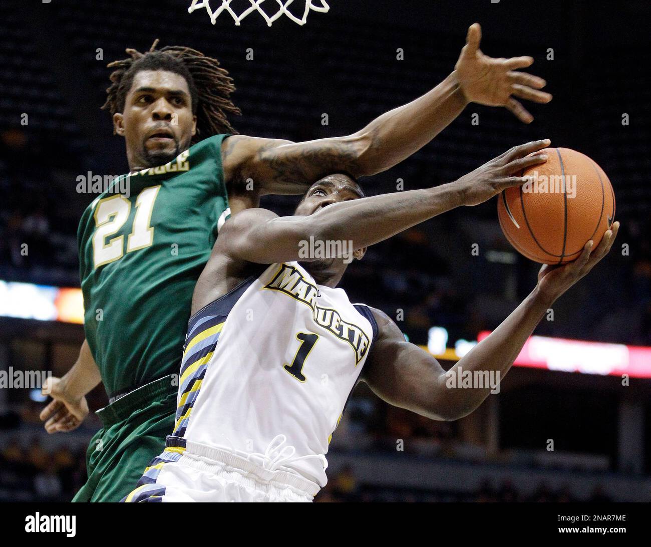 Marquette's Darius Johnson-Odom (1) is fouled by Jacksonville's Delwan ...