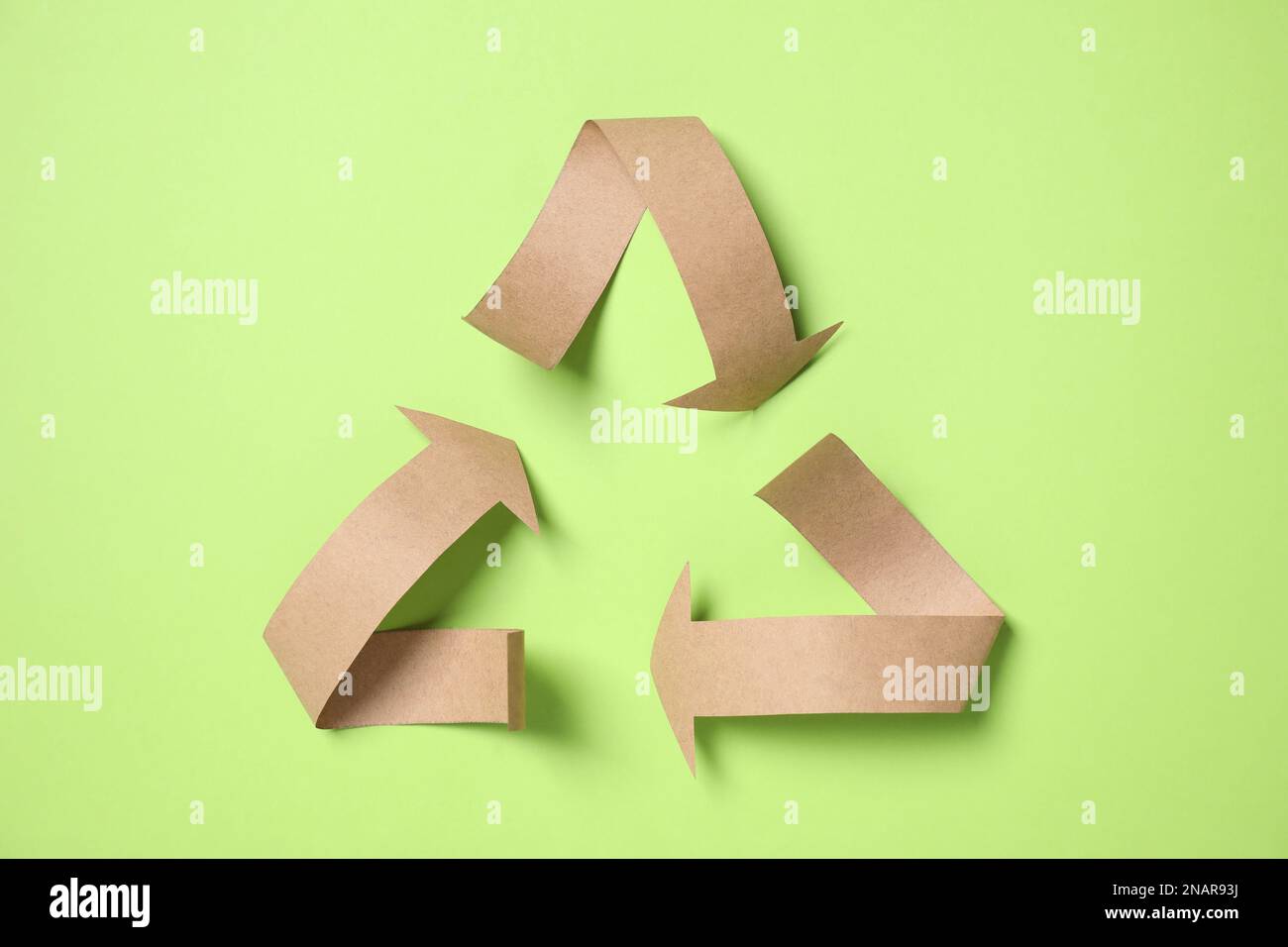 Recycling symbol cut out of paper on green background, top view Stock ...