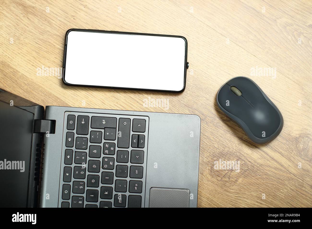 laptop with smartphone and computer mouse on boards from above Stock ...