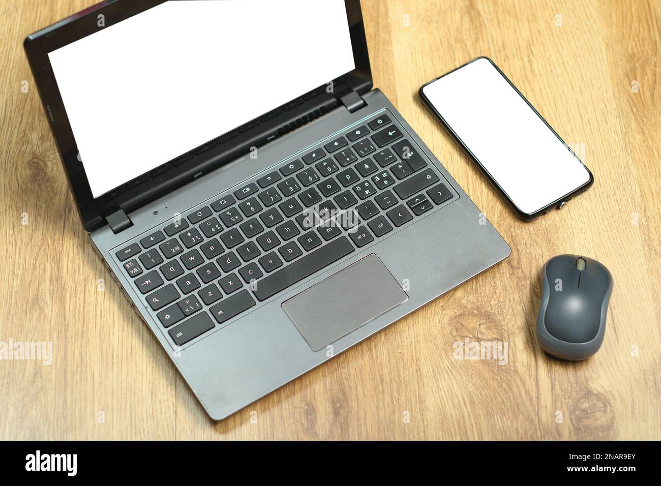 laptop with smartphone and computer mouse on boards from above and ...