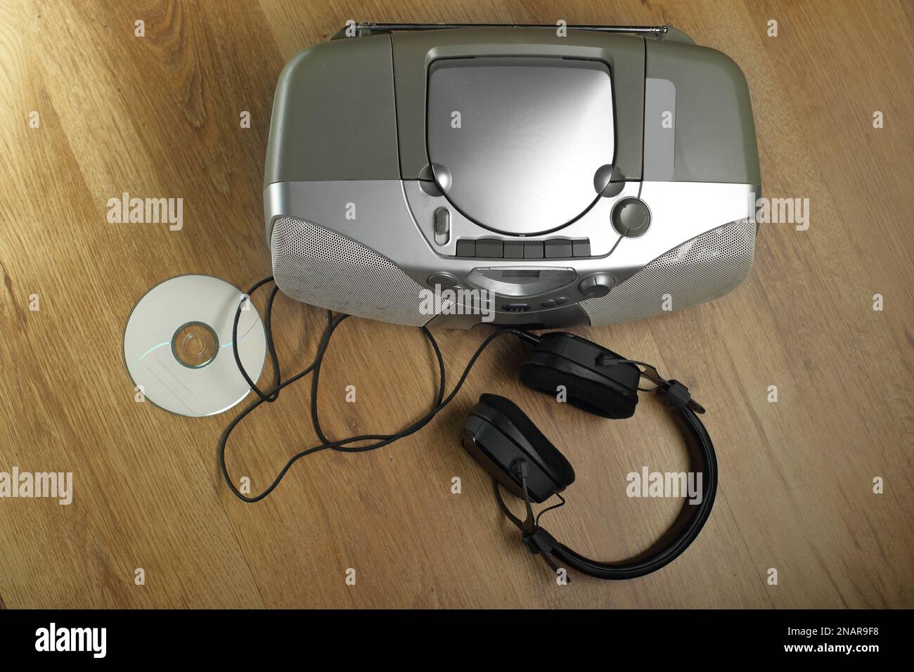 old radio tape recorder with record and headphones on the panel floor ...