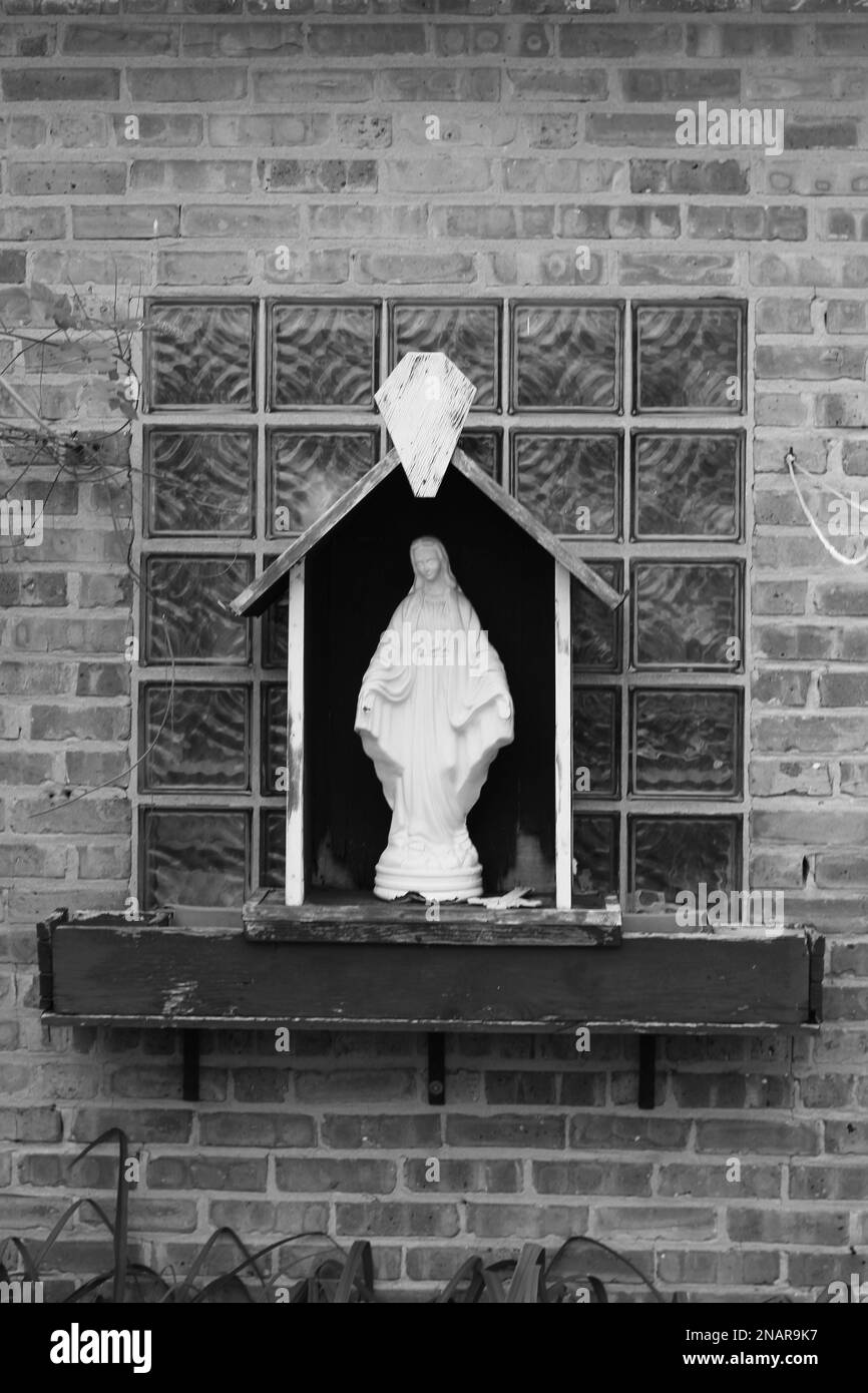 Typical common statue of the Virgin Mary standing against a common ...