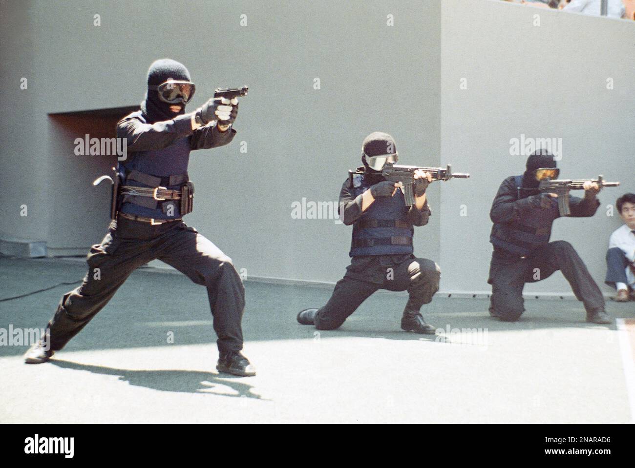 Three South Korean security agents take aim and shoot at an imaginary ...