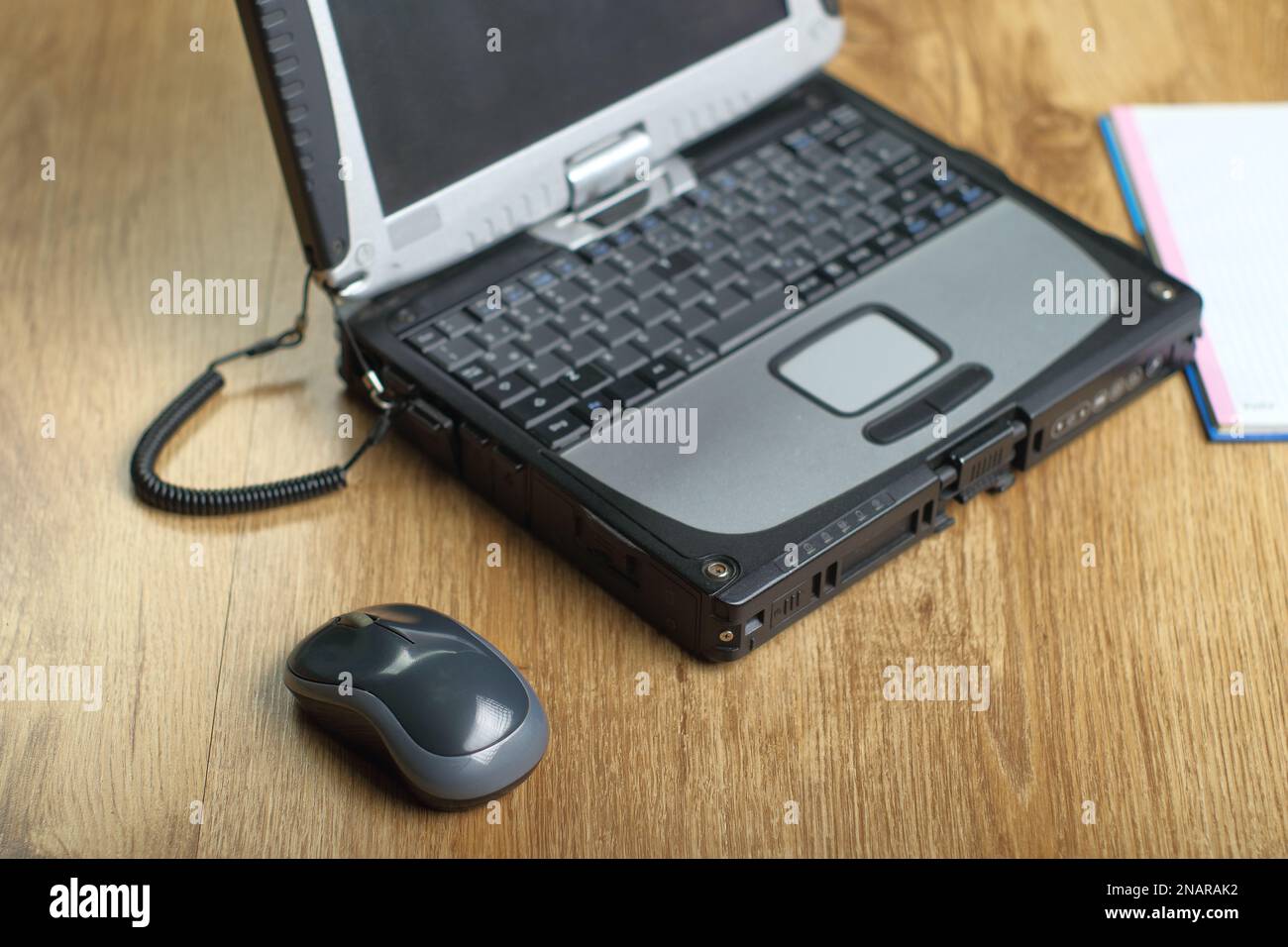 computer mouse next to the laptop on the panels Stock Photo - Alamy