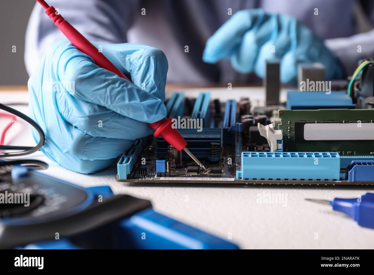 Technician repairing electronic circuit board at table, closeup Stock Photo - Alamy