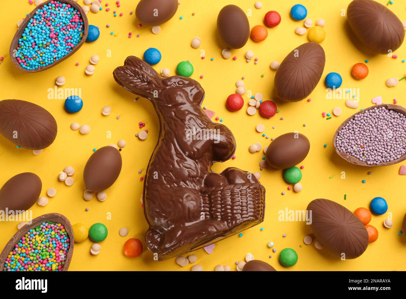 Flat lay composition with chocolate Easter bunny, eggs and candies on ...