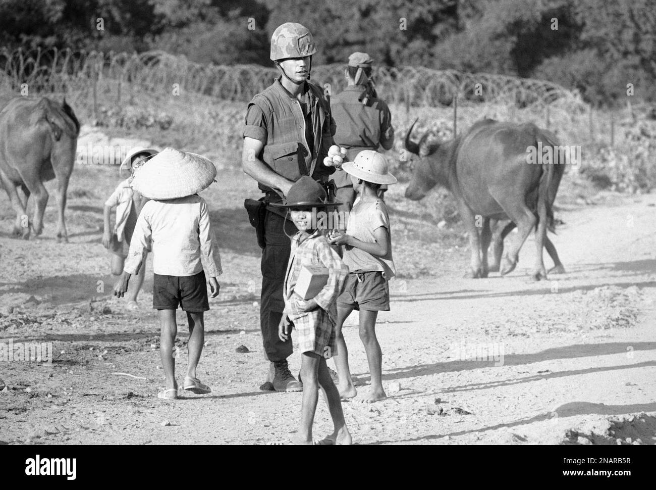 Vietnamese children living in a nearby hamlet crowd around Capt ...
