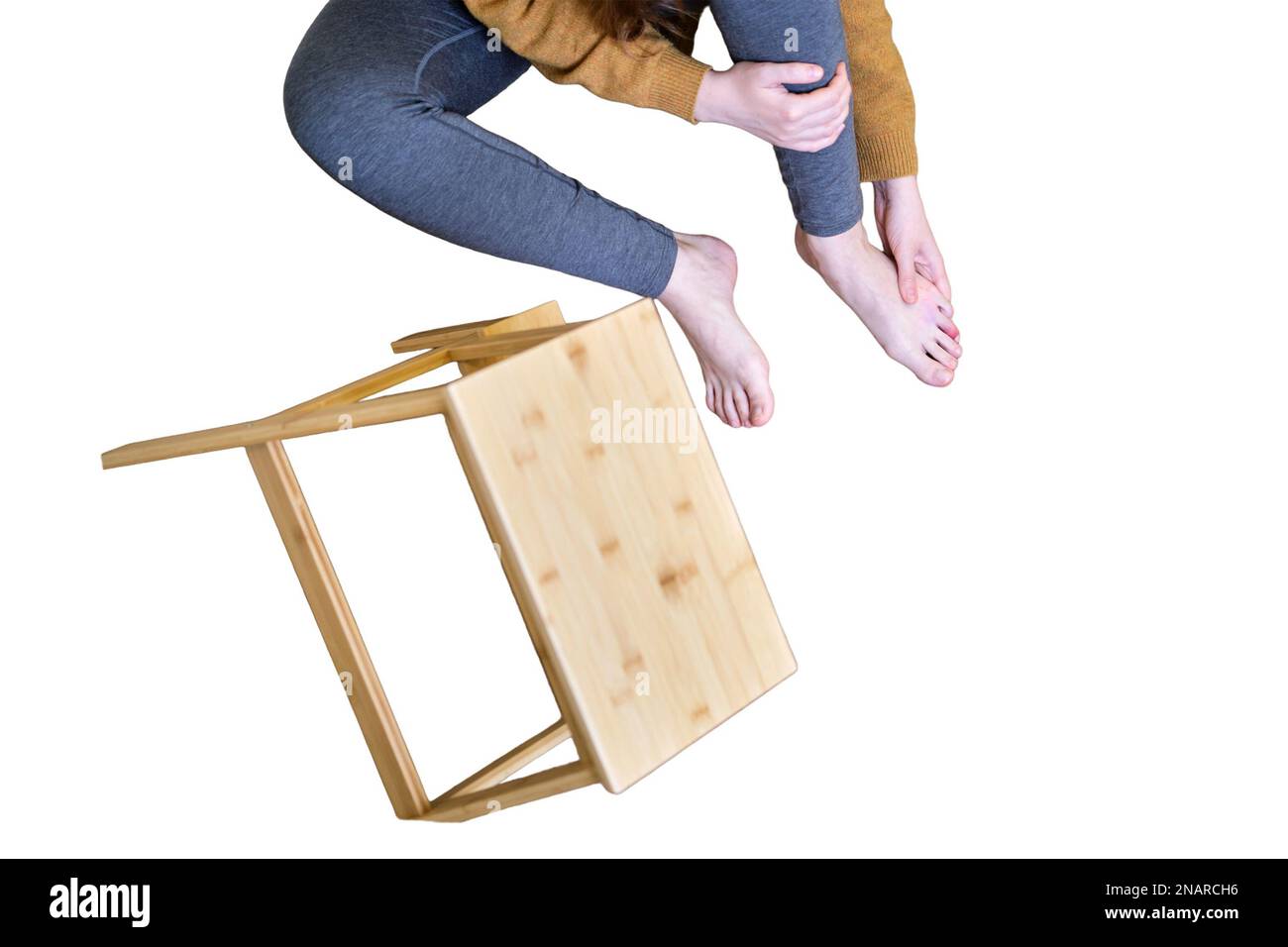 A man holds on to his injured leg after falling from a wooden ladder ...