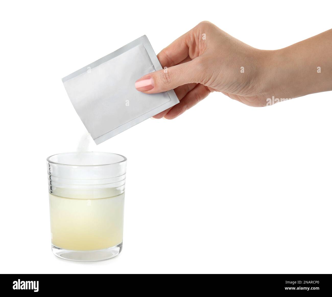 Woman pouring powder from medicine sachet into glass of water on white ...