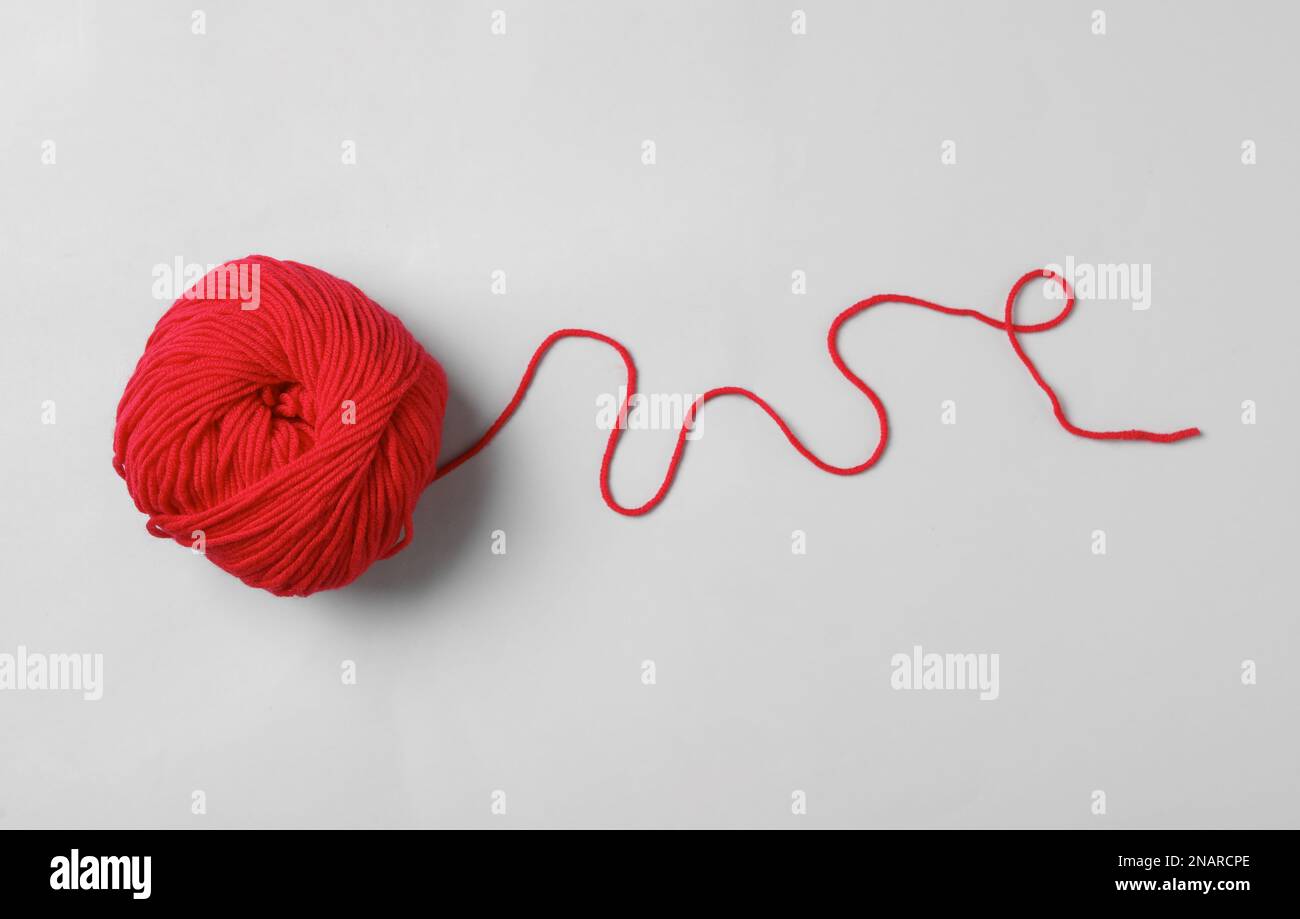 Soft red woolen yarn on white background, top view Stock Photo - Alamy