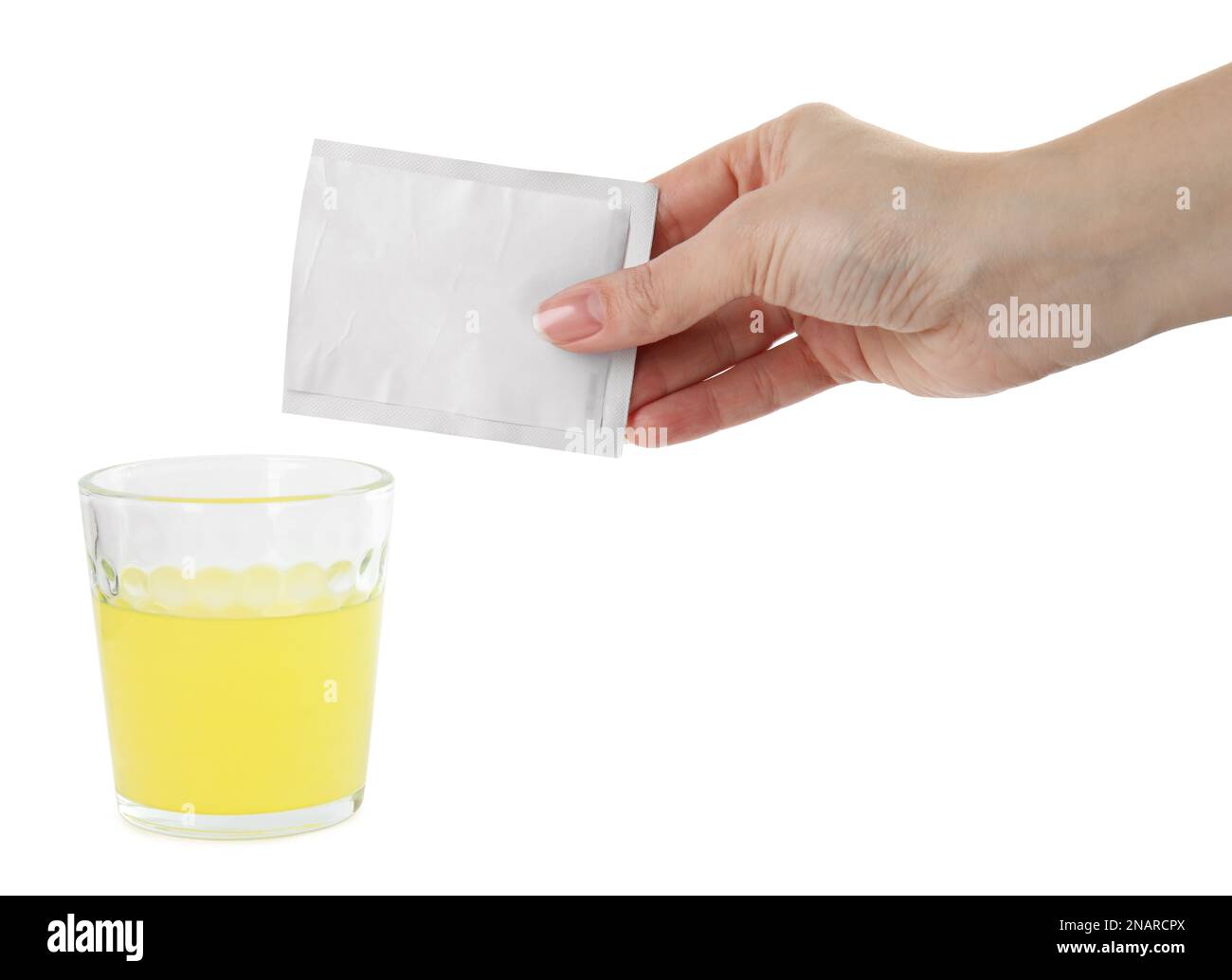 Woman pouring powder from medicine sachet into glass of water on white ...
