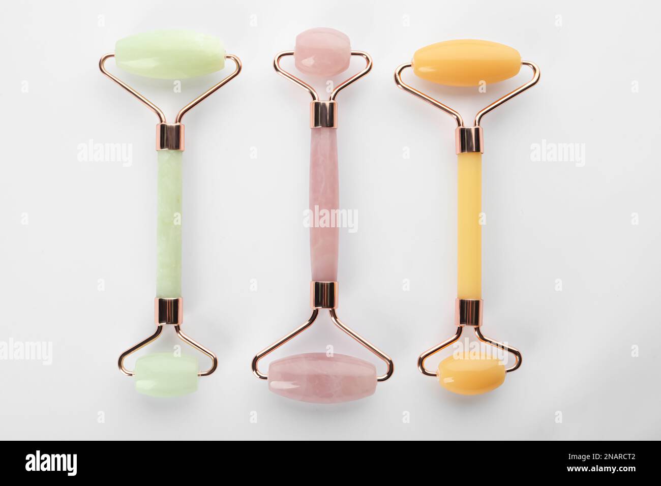 Different natural face rollers on white background, top view Stock ...