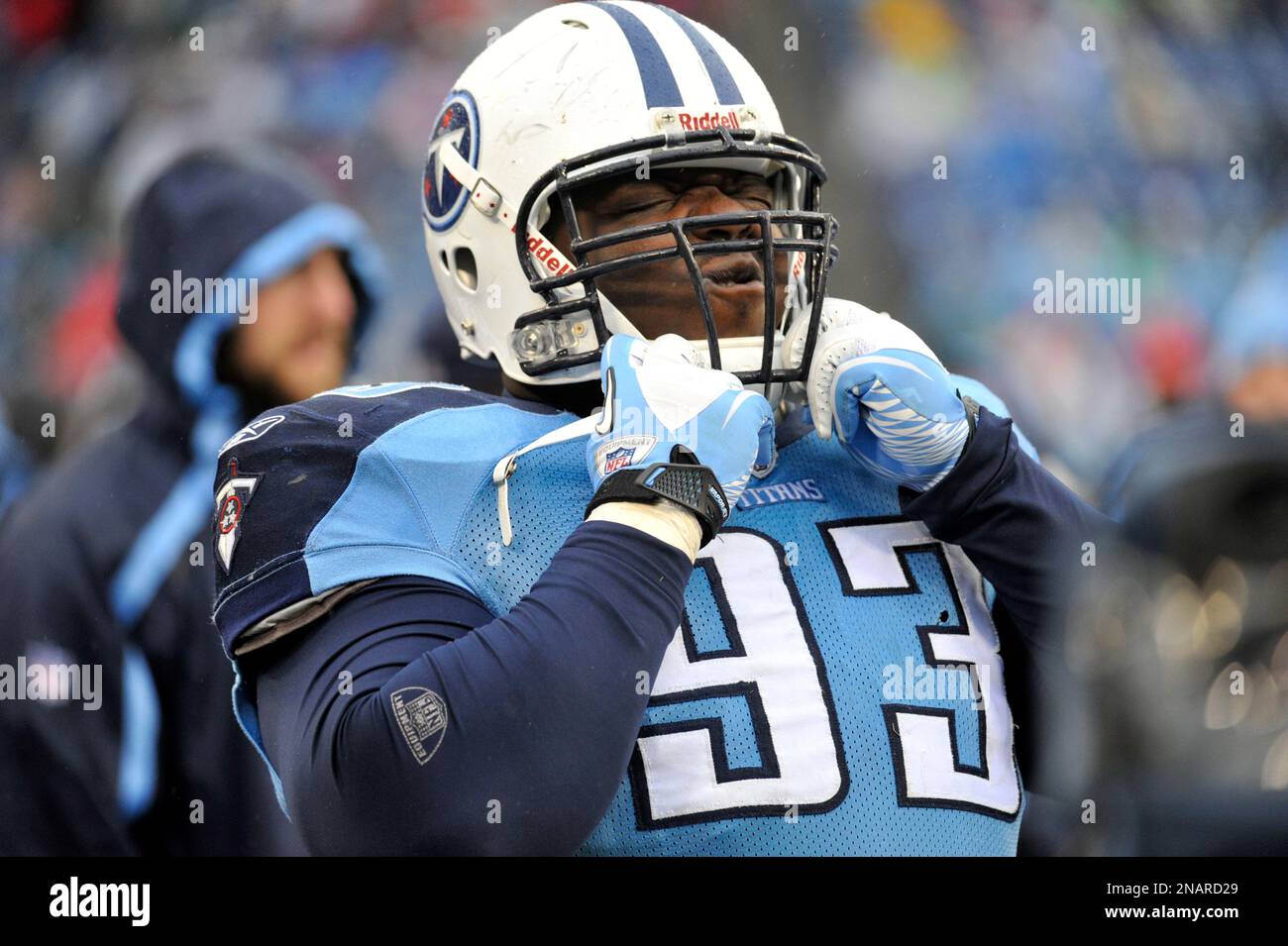 Tennessee Titans defensive tackle Shaun Smith pulls his helmet on in ...