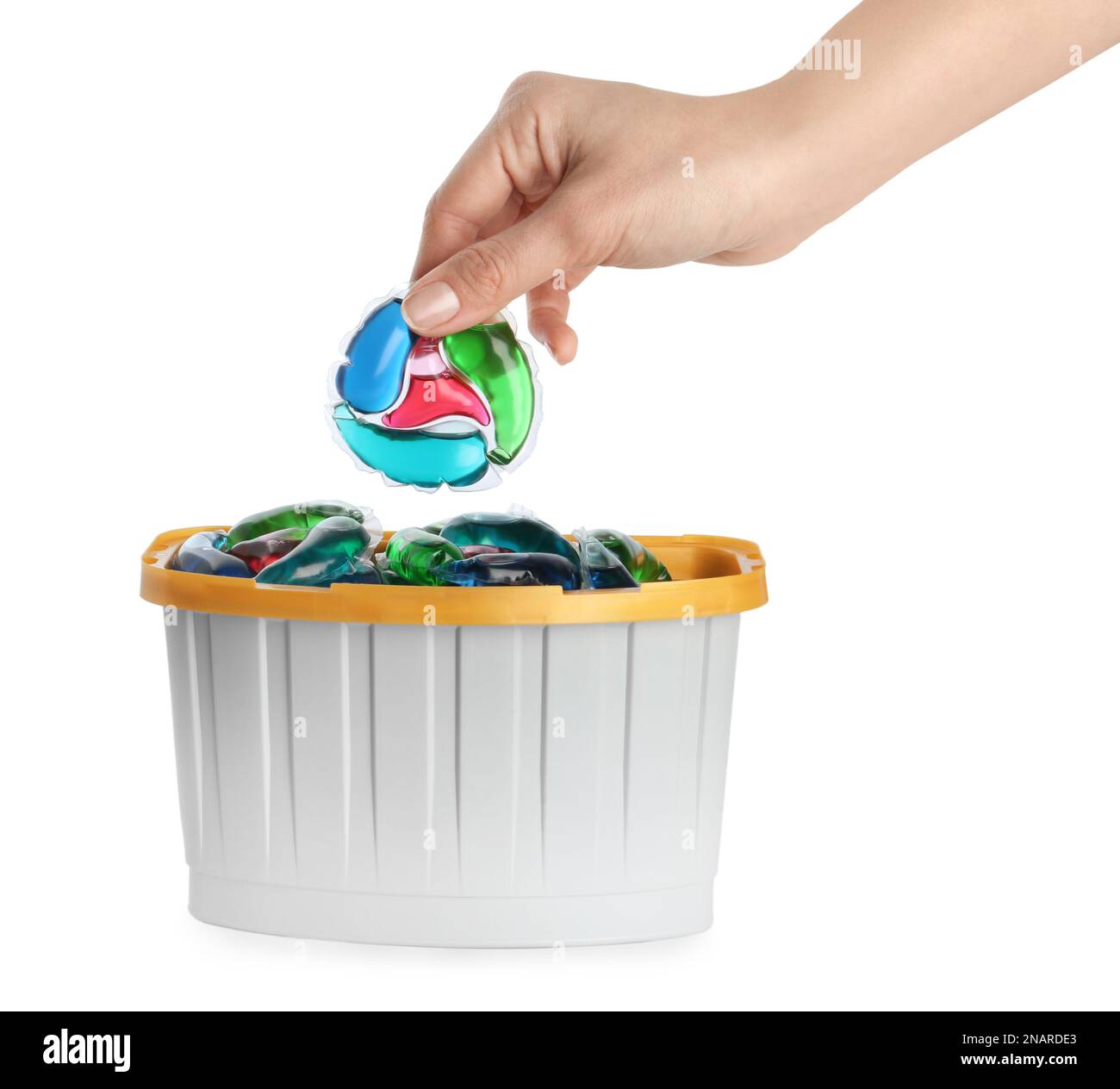 Woman taking laundry capsule out of box against white background ...