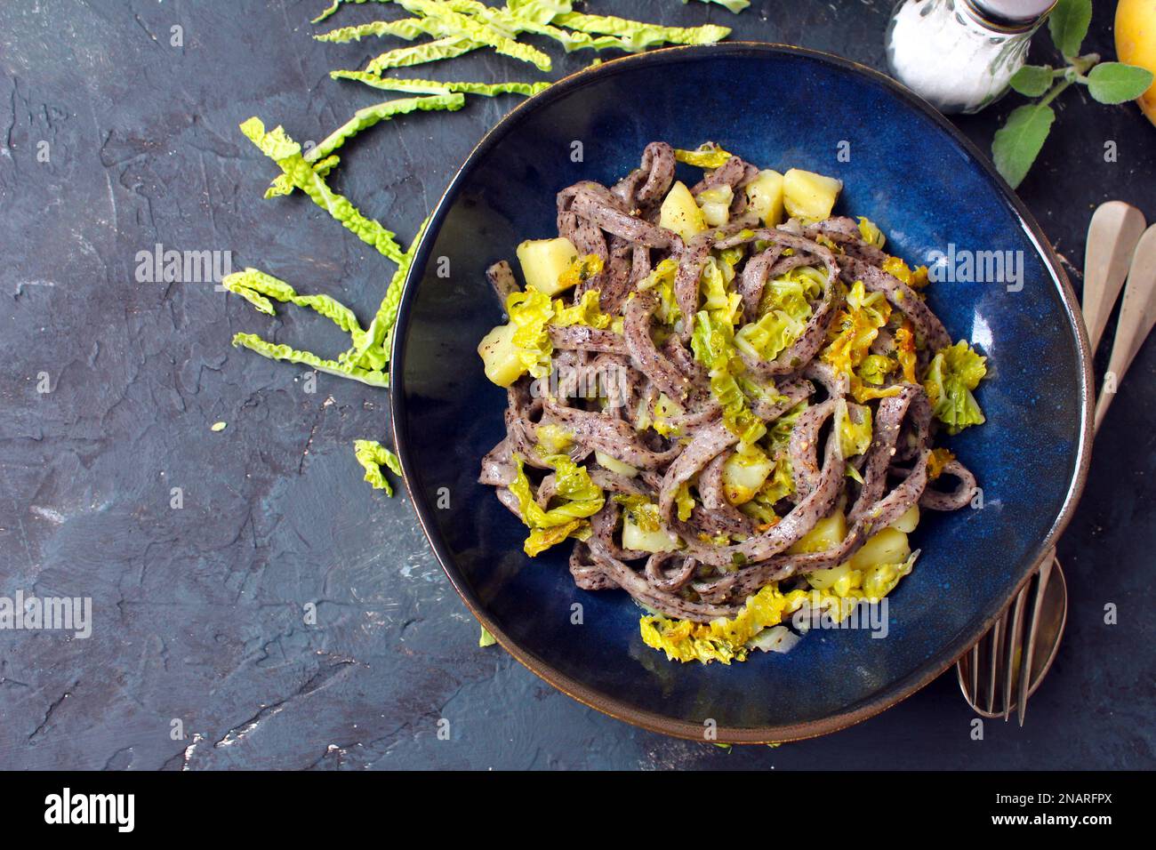 Homemade buckwheat pasta Pizzoccheri with cabbage and potatos. Top view ...