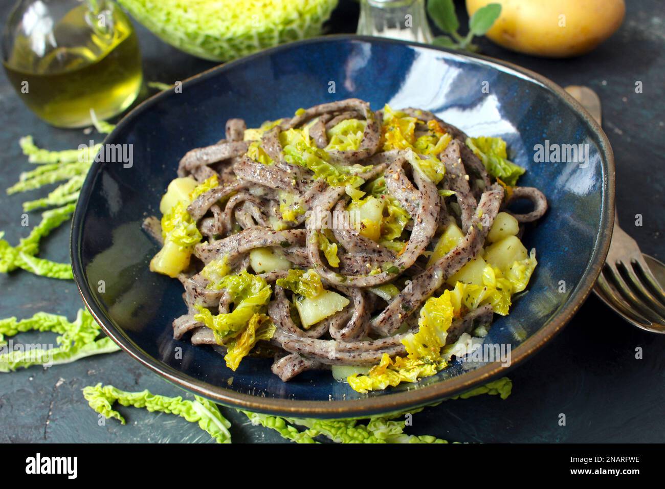 Homemade buckwheat pasta Pizzoccheri with cabbage and potatos. Top view ...