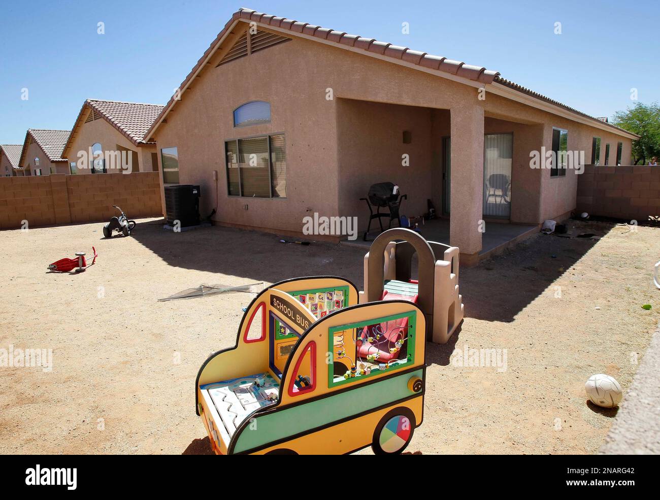 In this photo taken June 9, 2011, toys sit on the ground and a bullet ...