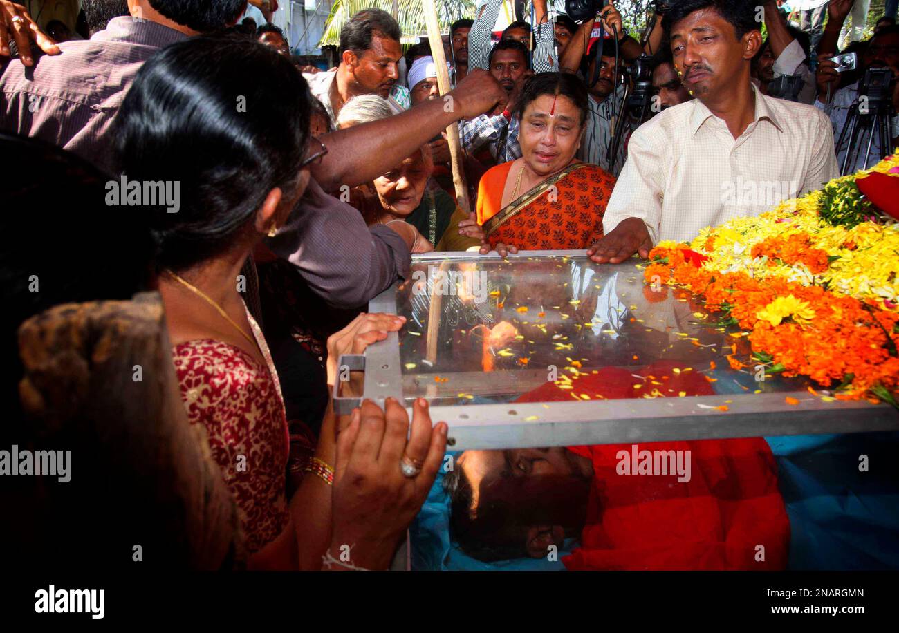Relatives and supporters wail near the body of Kishenji, a senior ...